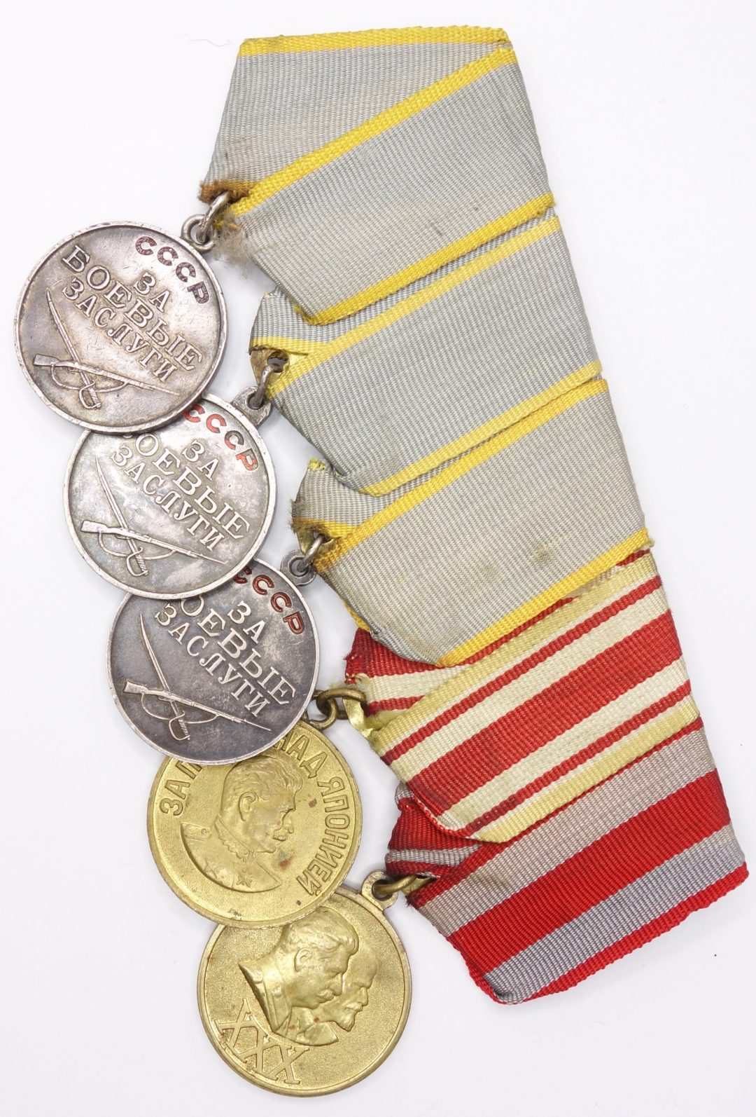 Group of Soviet medals consisting of 3 medals for Combat Merit, Medal ...